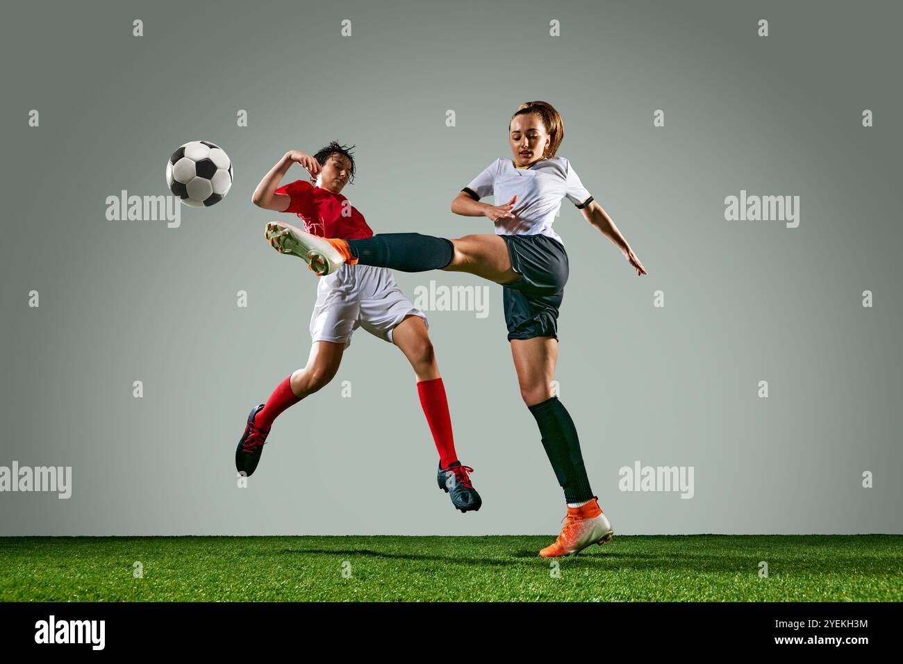 Competitive moment between two female soccer players in dynamic motion ...