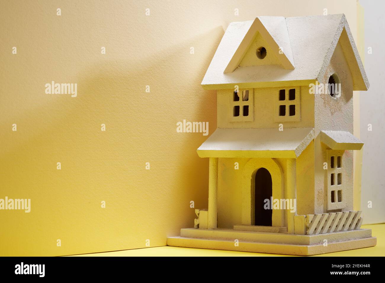 miniature model house on yellow background Stock Photo - Alamy