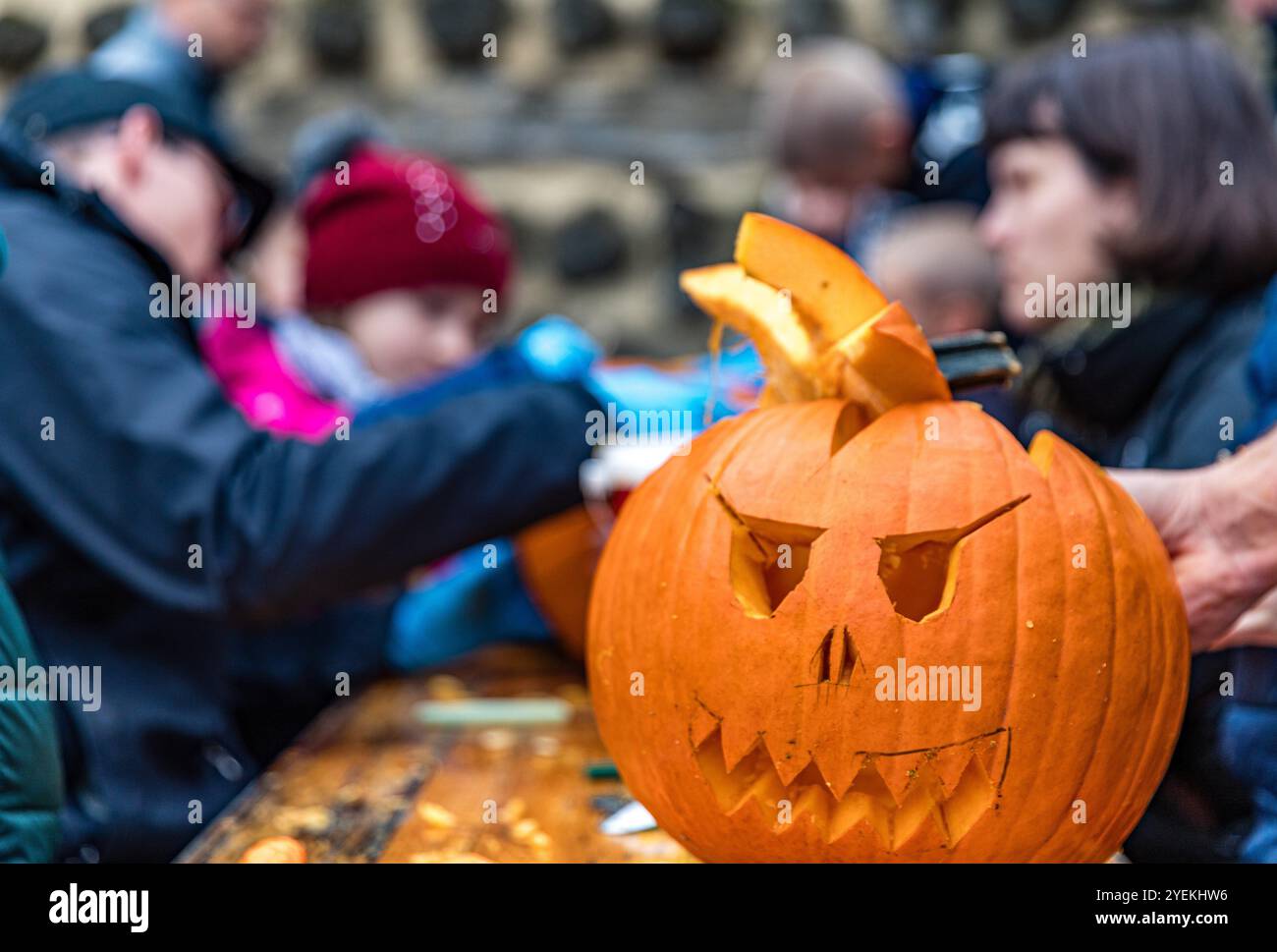 31 October 2024, Brandenburg, Raddusch: Children sit with their parents ...