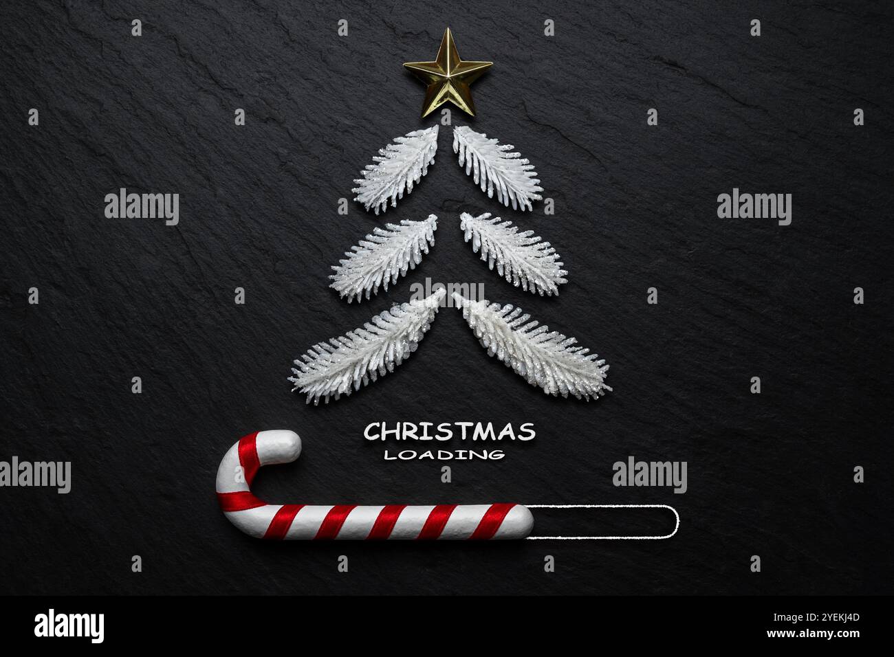 Fir tree and candy cane on black stone background. Minimal Christmas ...