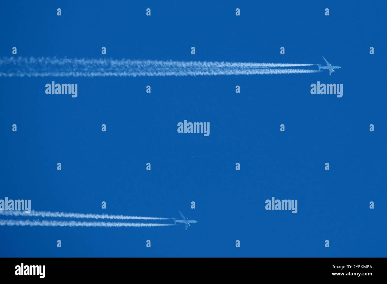 Airplane trails in the blue sky, contrails Stock Photo - Alamy