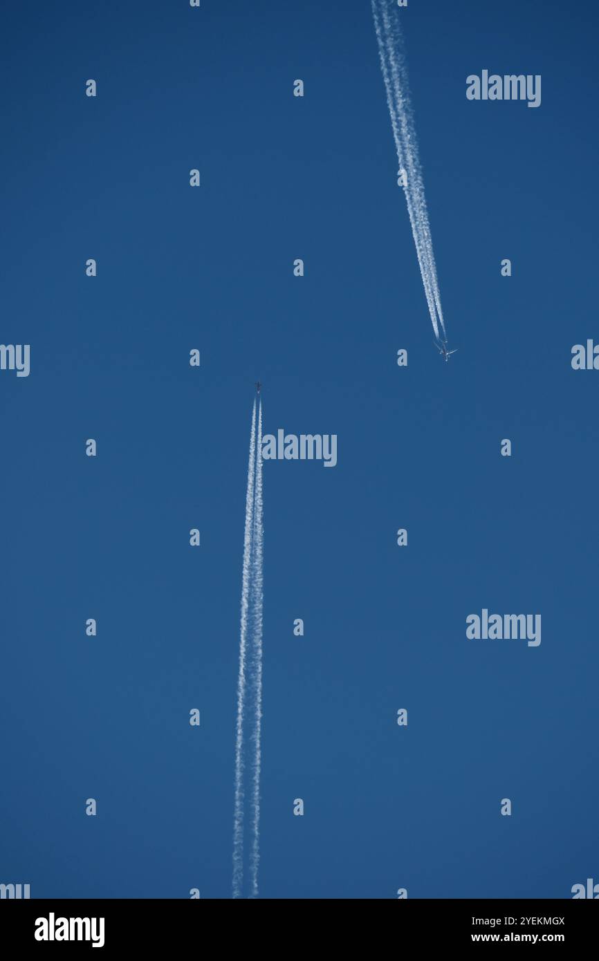 Airplane trails in the blue sky, contrails Stock Photo - Alamy