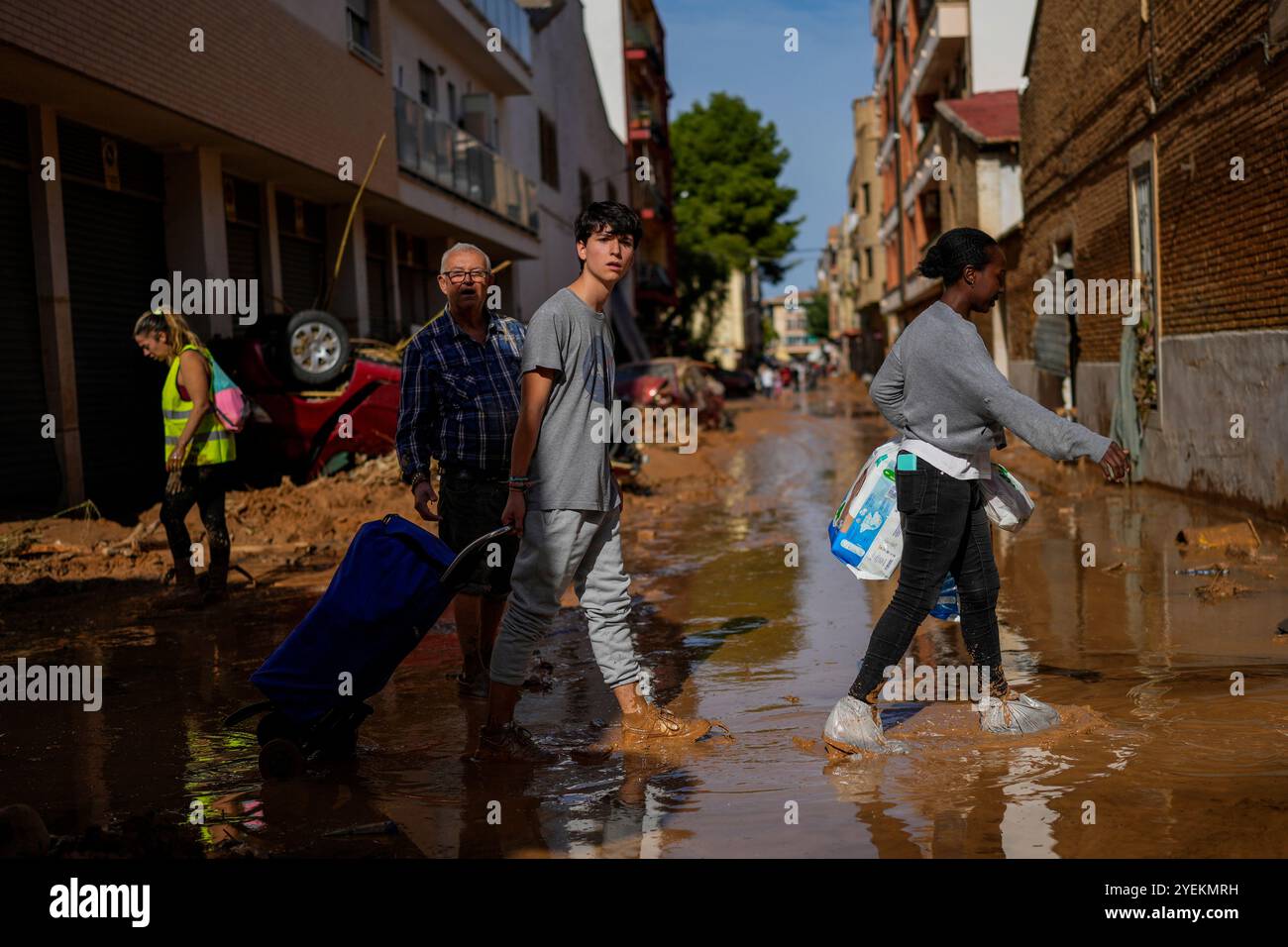 People walk in an area affected by floods in Valencia, Spain, Thursday ...