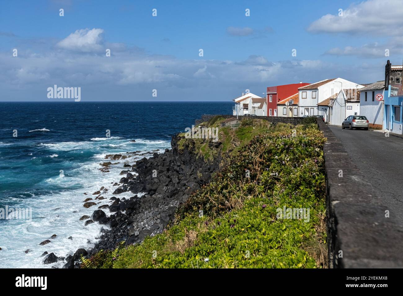 Bright houses on the cliff at Atlantic ocean coast in Azores islands ...