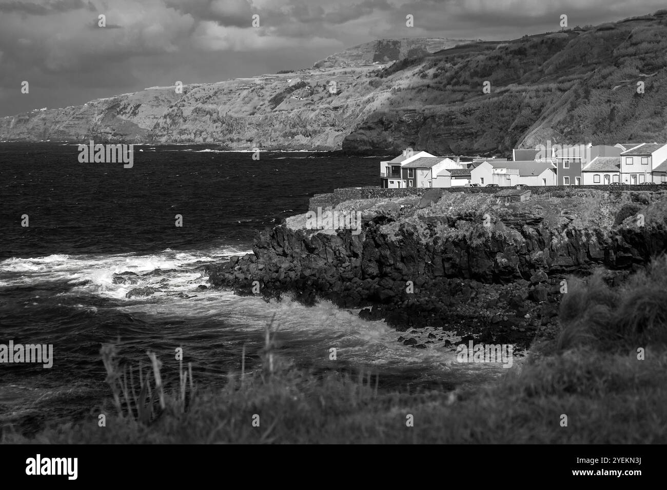 Bright houses on the cliff at Atlantic ocean coast in Azores islands ...