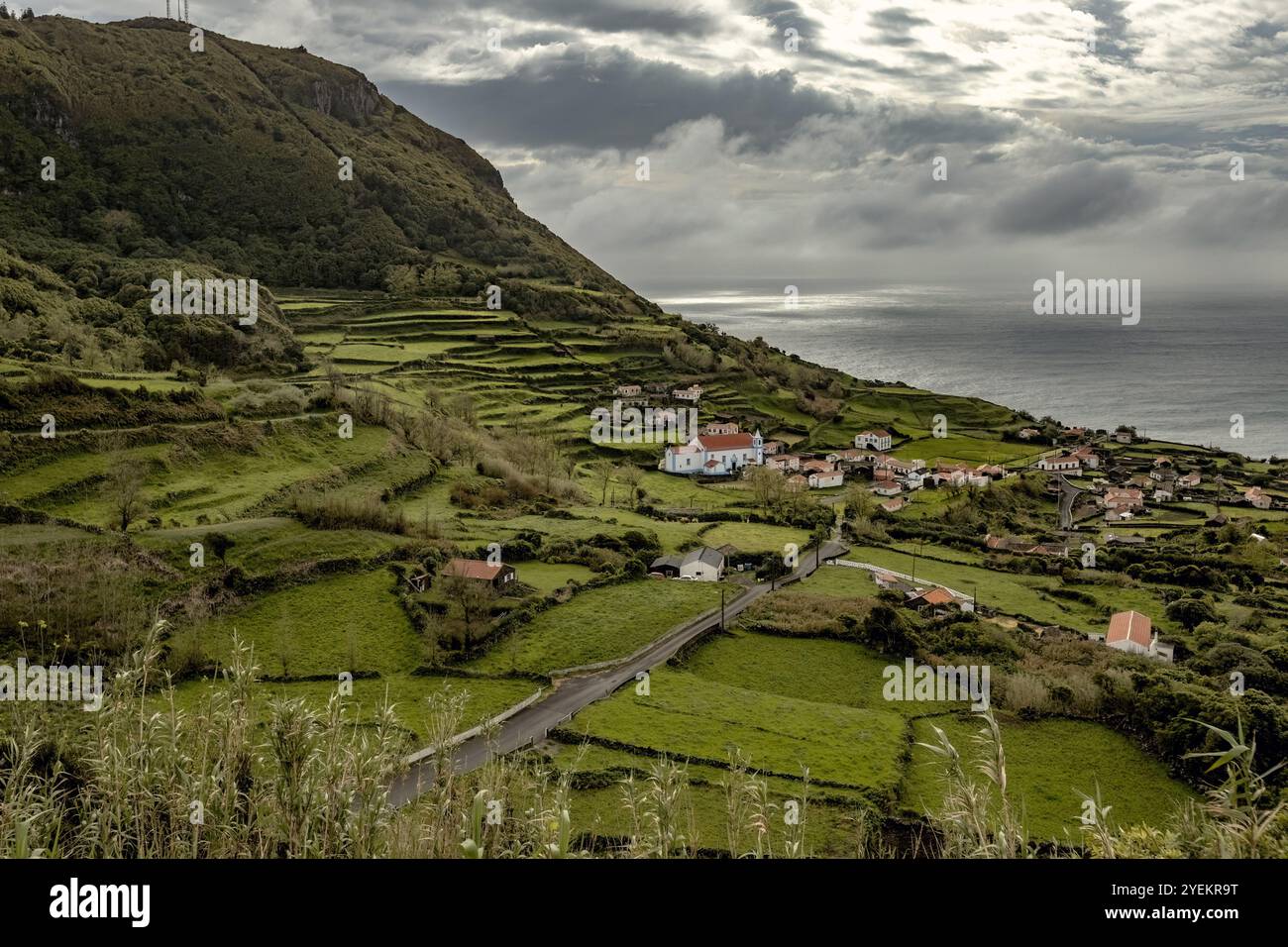 Small village with stone houses anf a white church in Flores island ...