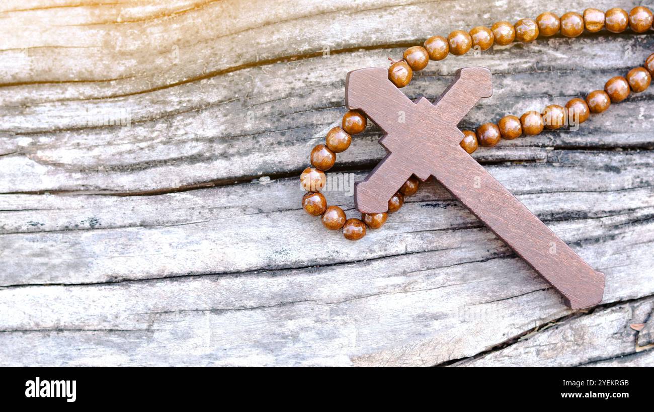 Dark red wooden cross on wooden background symbolizing the spread of ...