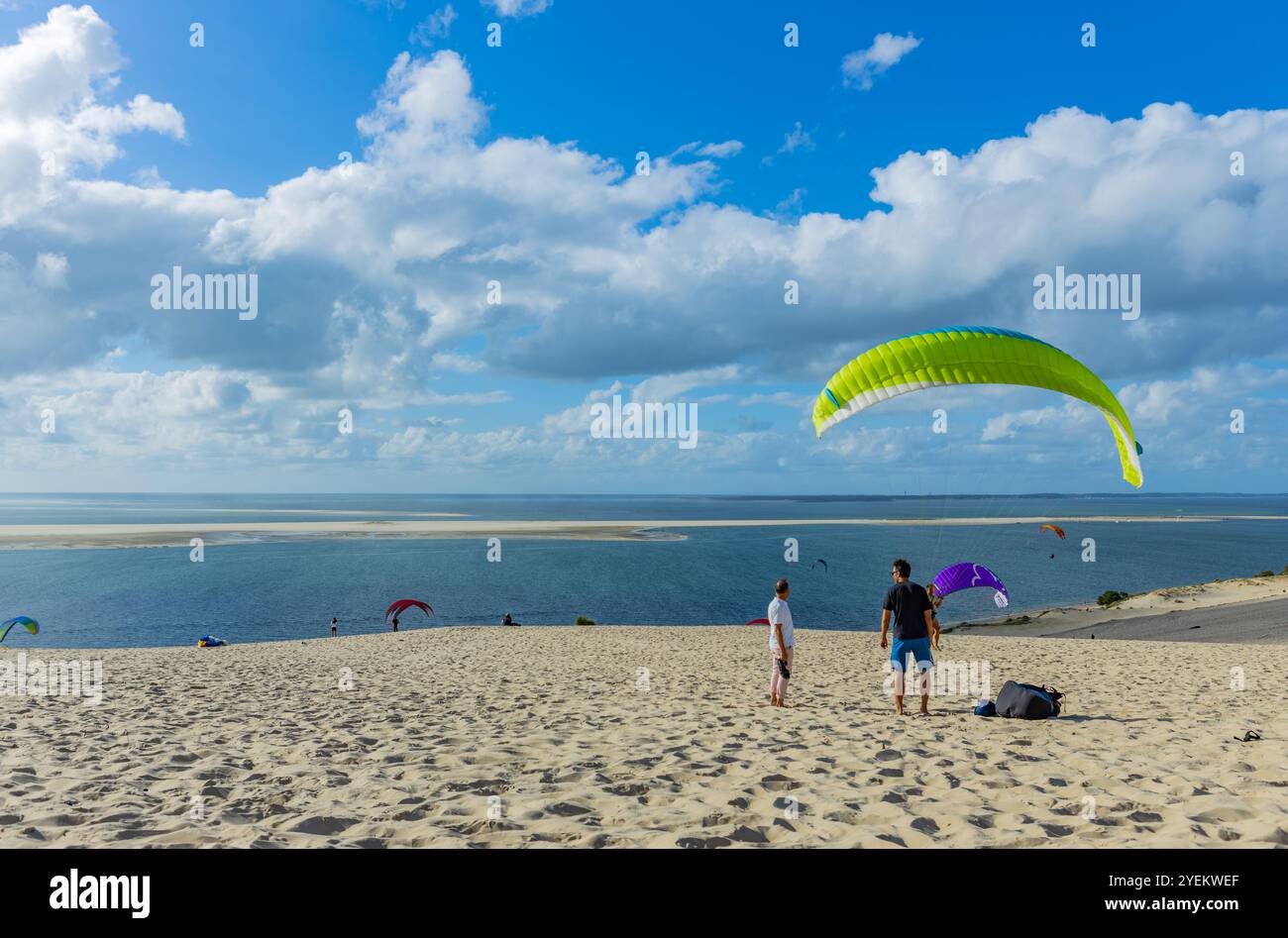 Dune of Pilat, France - August 14, 2024: People paragliding at the ...
