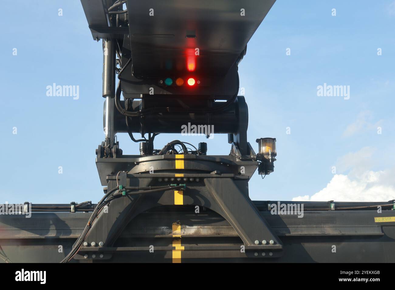 Close-up of a laden reach stacker lifting a container, highlighting the ...