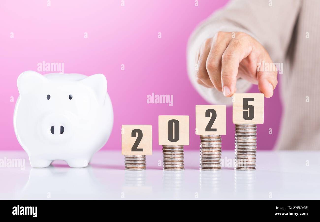 A businessperson arranges wooden blocks labeled '2025' on a rising ...