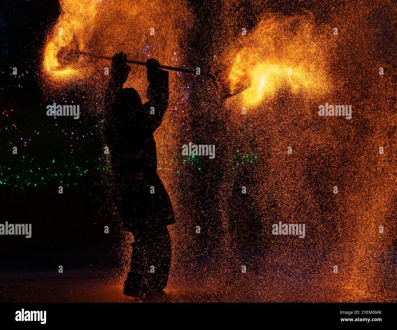 Fire pot performance showcasing a performer manipulating a fiery iron ...