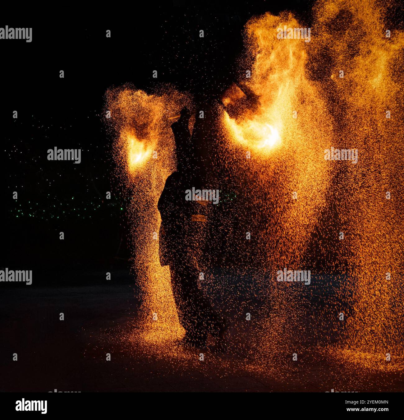 Fire pot performance showcasing a performer manipulating a fiery iron ...