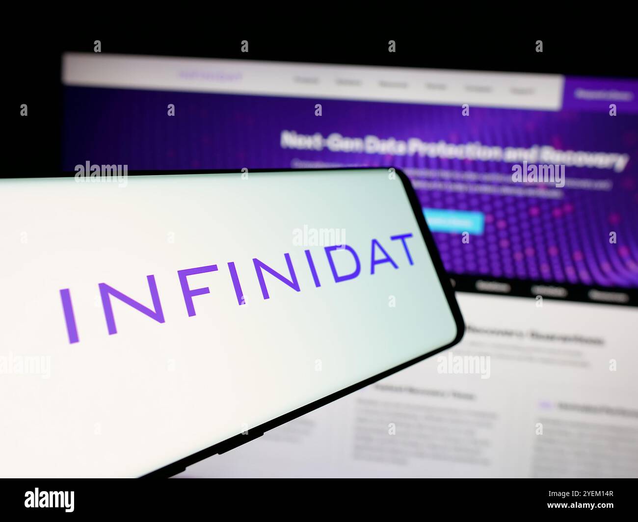 Mobile phone with logo of data storage company Infinidat Ltd. on screen in front of business ...