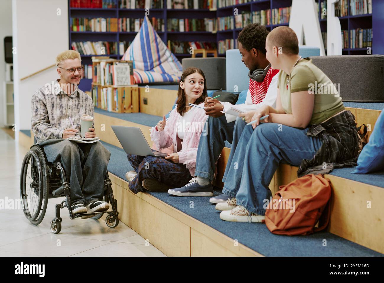 Group of diverse students engaging in an animated study session while ...