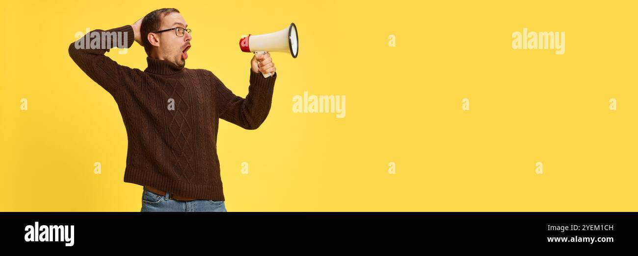 Banner. Young man dressed casual attire loudly shouting to megaphone ...