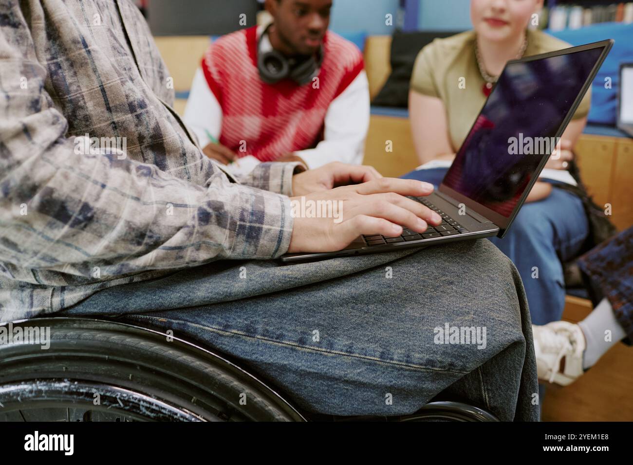 Group of students collaborating in inclusive classroom, with person in ...
