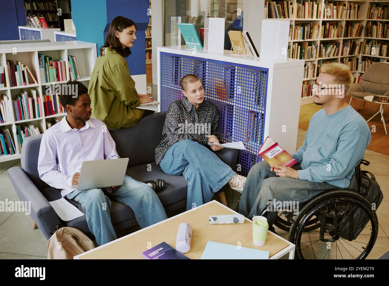 Group of diverse students studying in library, engaging in discussion ...