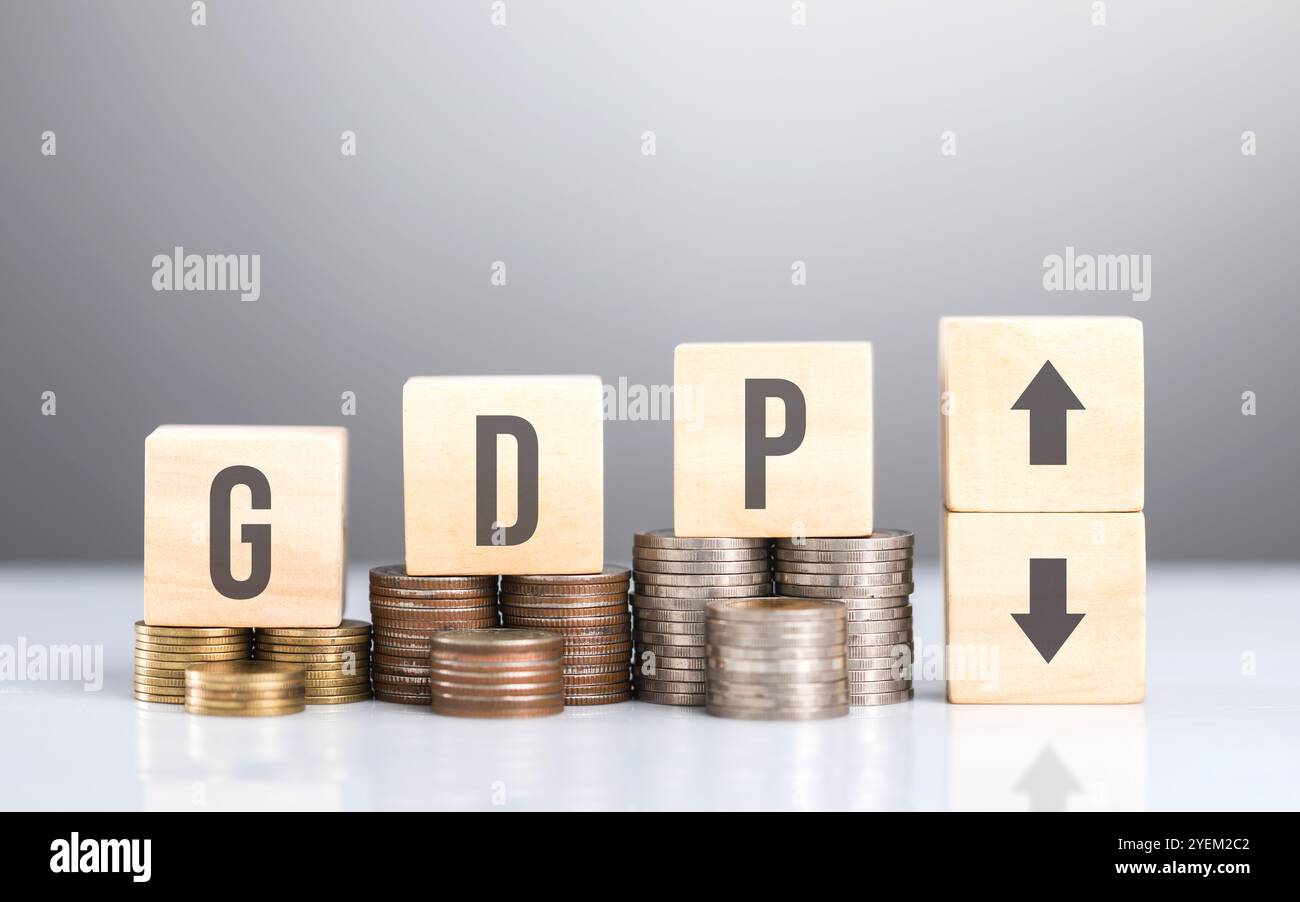 A wooden block labeled 'GDP' alongside a stack of coins. Symbolizes ...