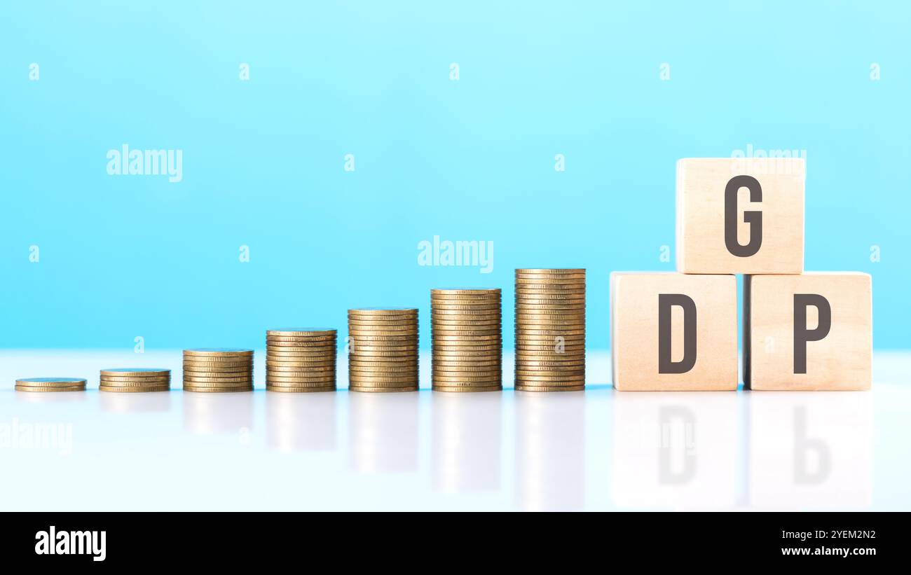 A wooden block labeled 'GDP' alongside a stack of coins. Symbolizes economic growth, emphasizing ...