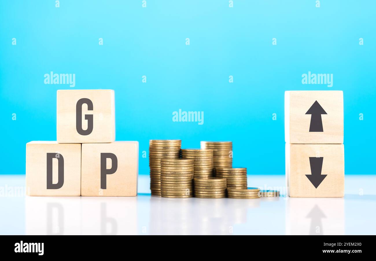 A wooden block labeled 'GDP' alongside a stack of coins. Symbolizes ...