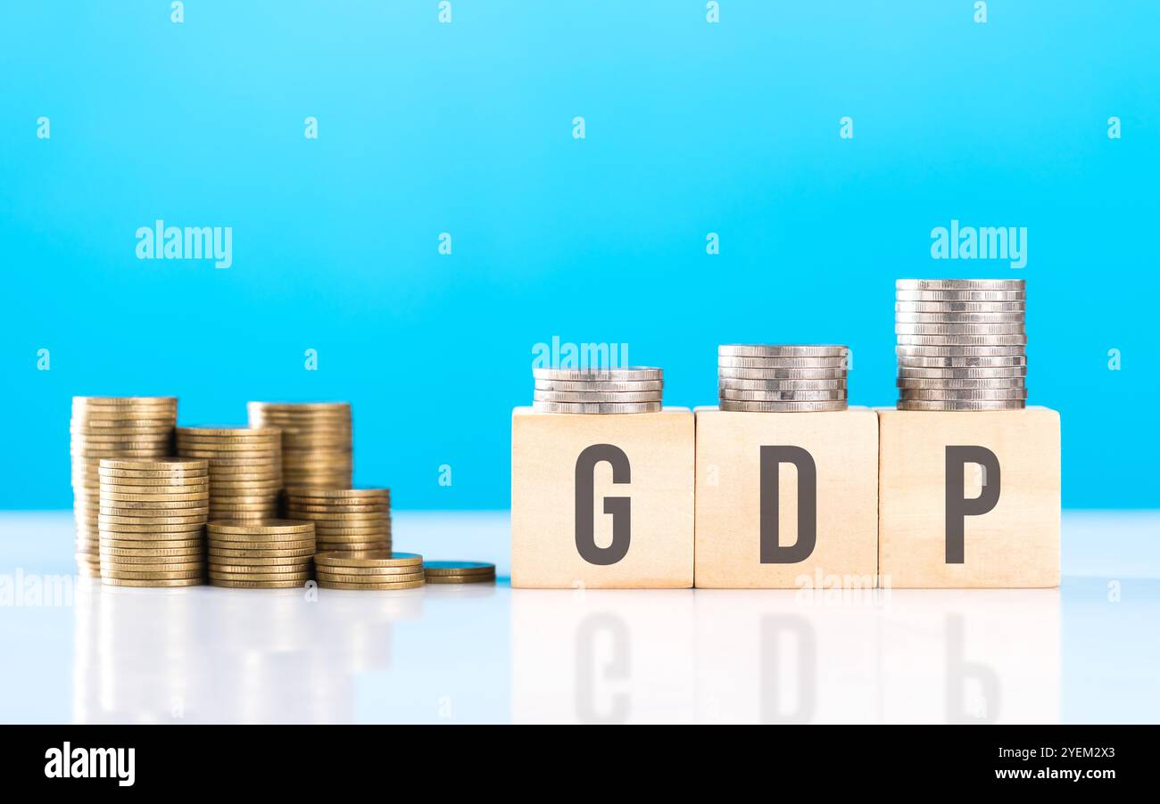 A wooden block labeled 'GDP' alongside a stack of coins. Symbolizes ...