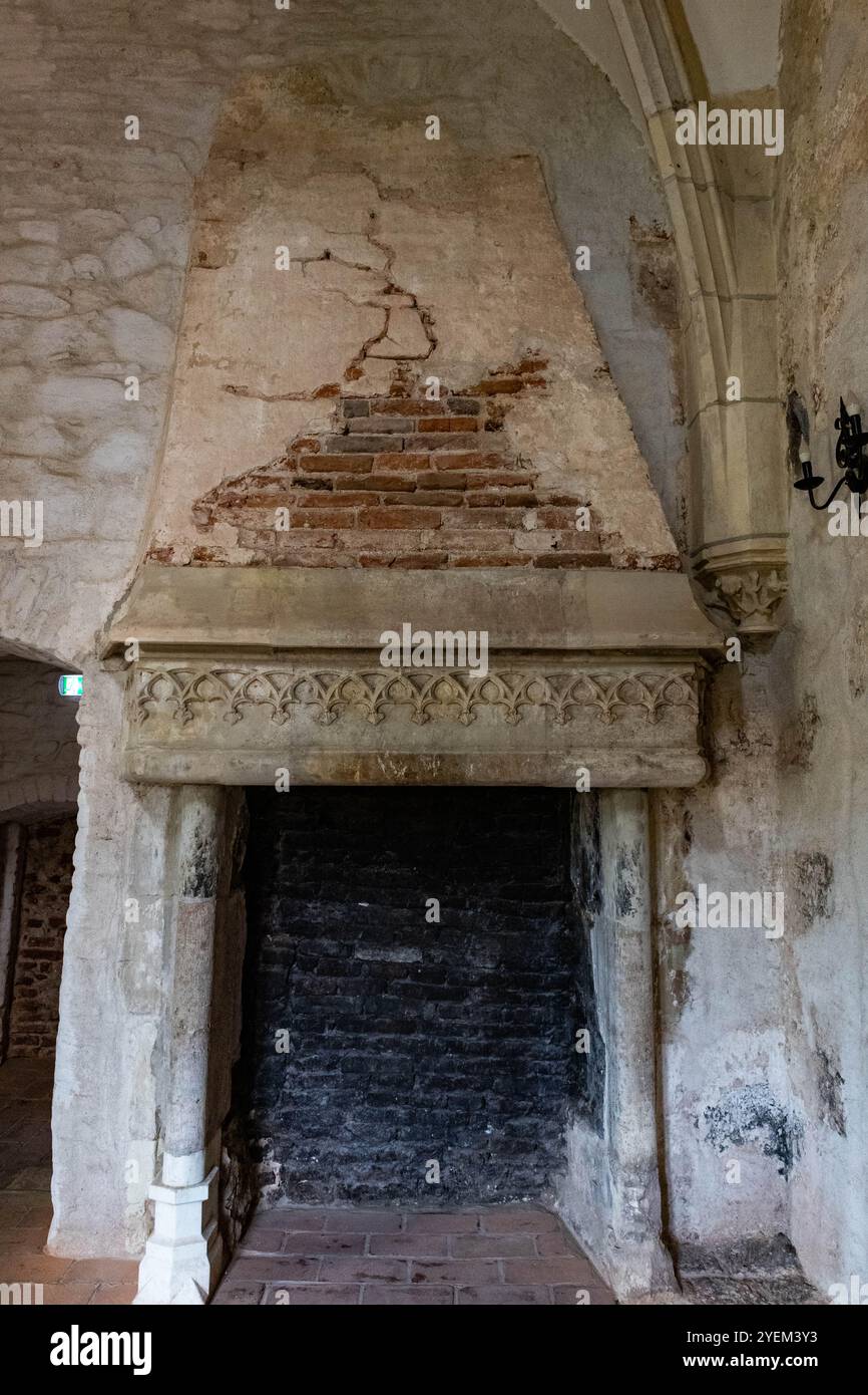 A captivating view of an abandoned fireplace in an old castle room ...