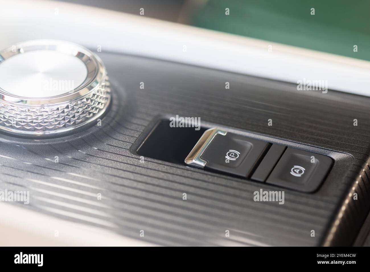 Hand pressing the electric parking brake button in an electric vehicle ...