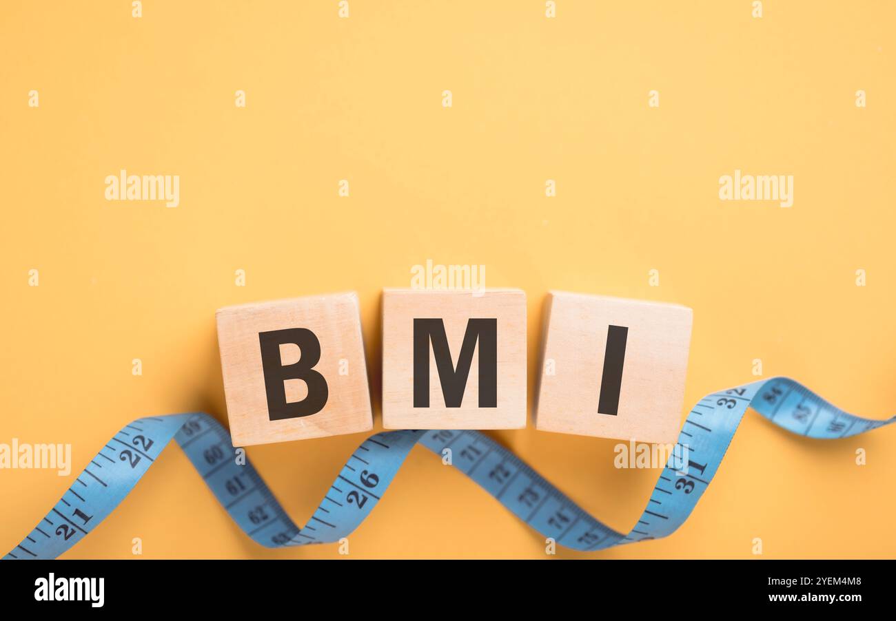 Top-view wooden block displaying 'BMI' next to a measuring tape on ...