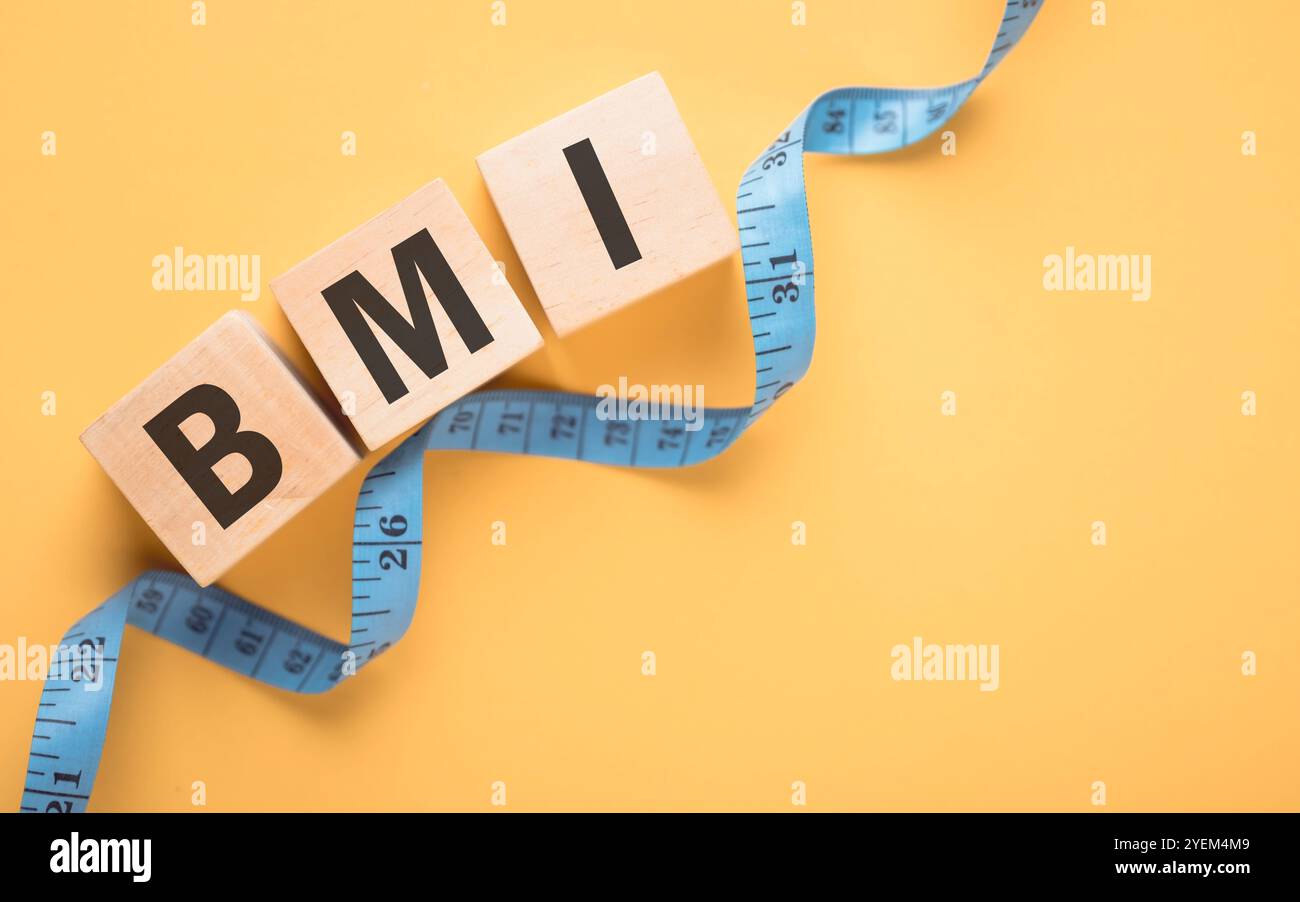 Top-view wooden block displaying 'BMI' next to a measuring tape on ...