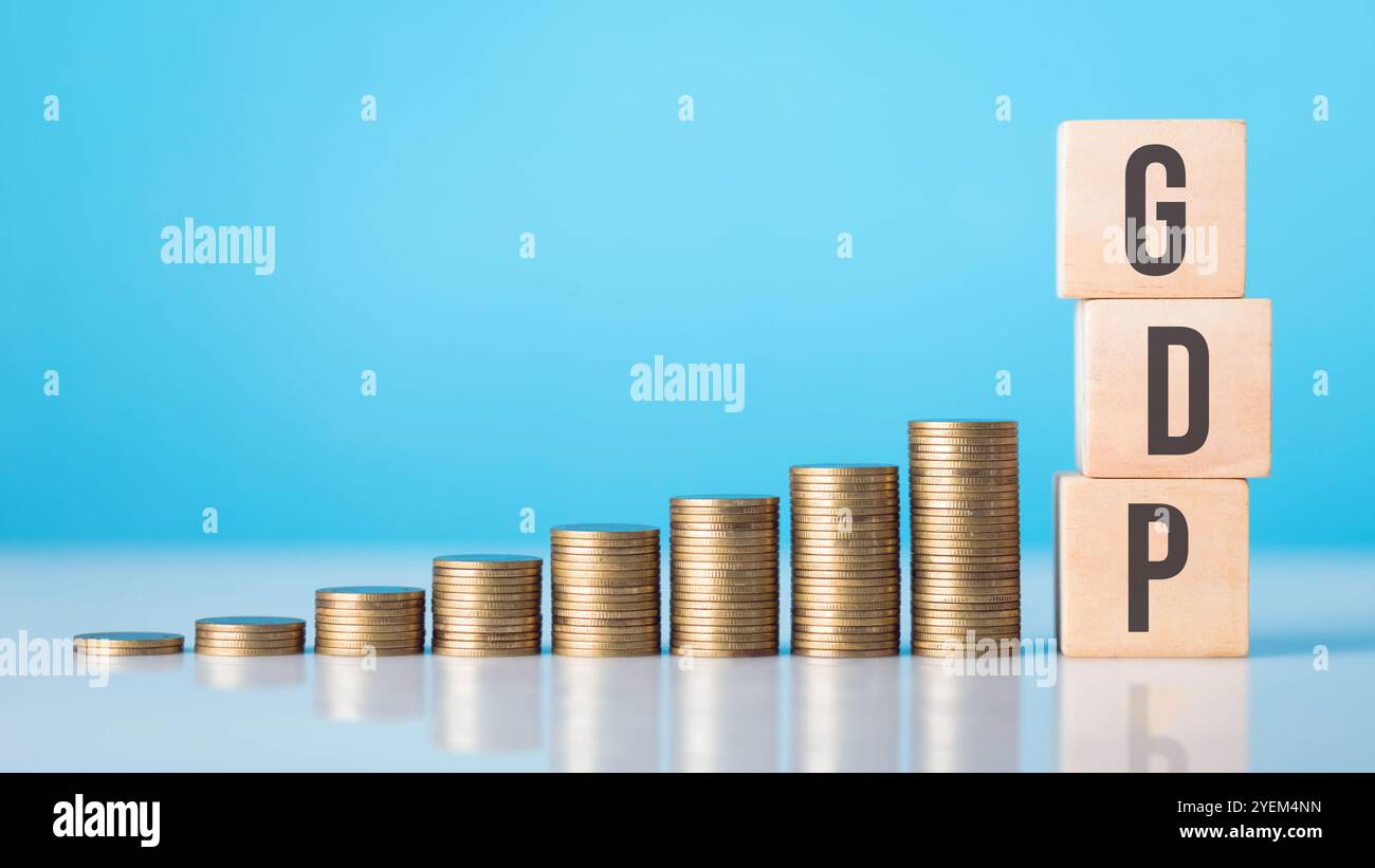 Wooden block labeled 'GDP' next to a stack of coins arranged from ...