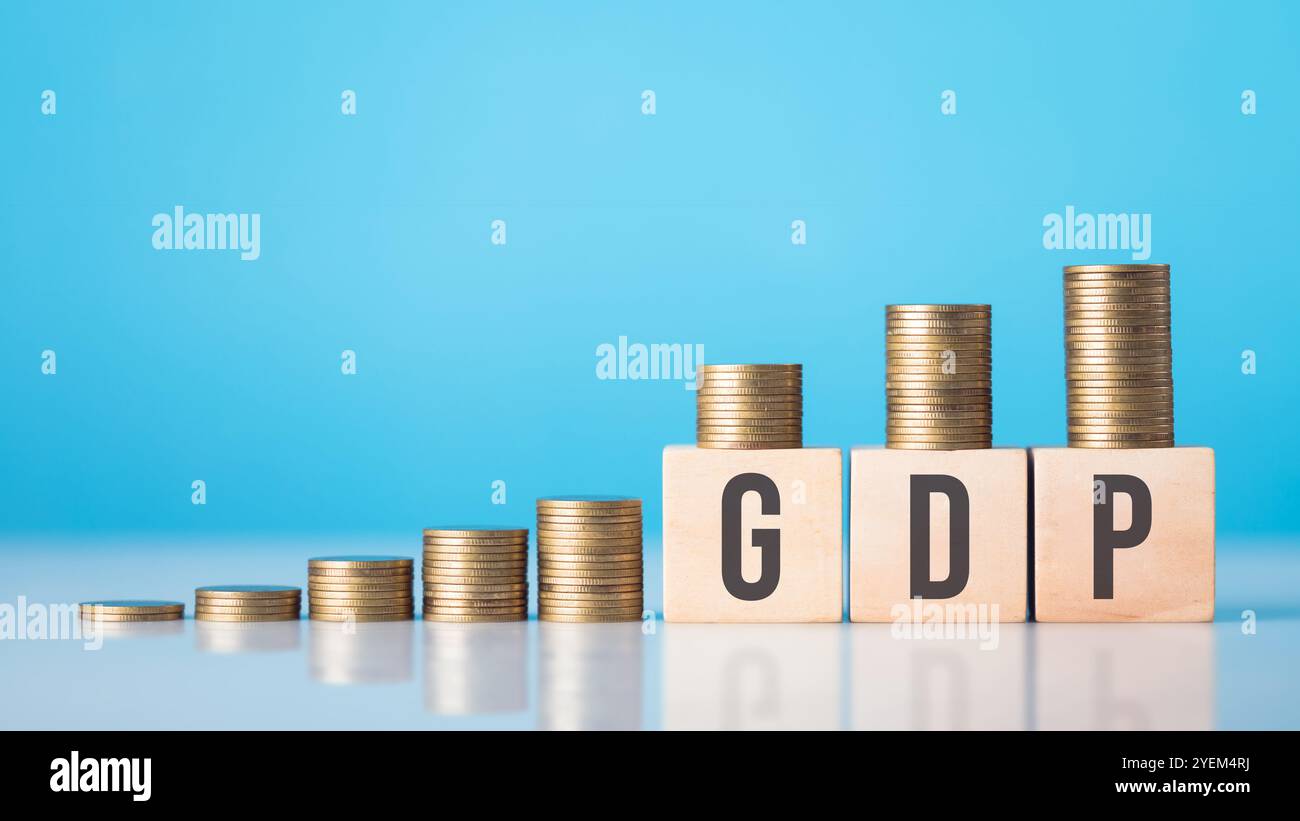 Wooden block labeled 'GDP' next to a stack of coins arranged from ...