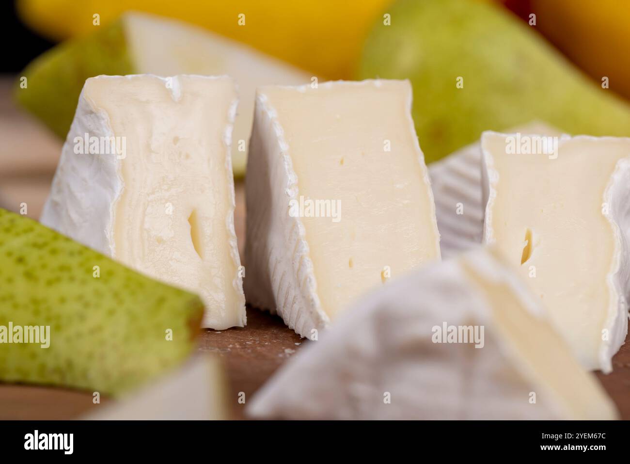 processed cheese with white mold close-up, fresh cheese on a cutting ...