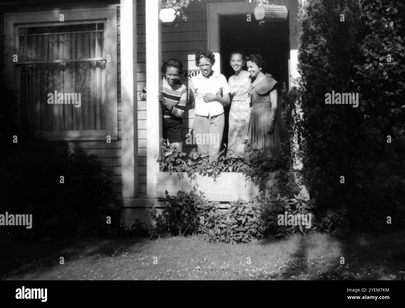 A group of suburban women stand together on a porch, ca. 1961 Stock ...