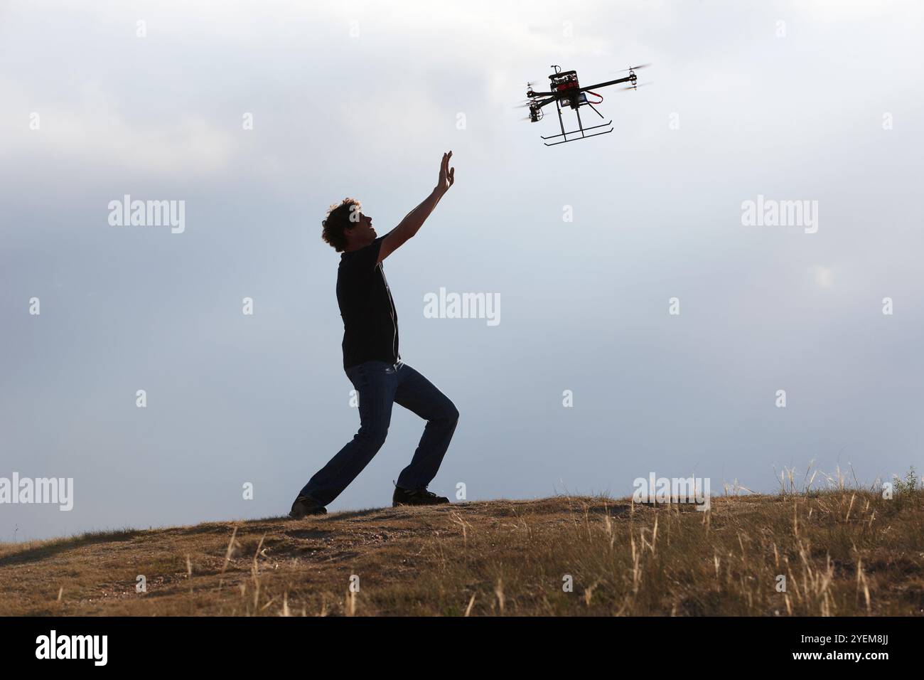Man trying to stop a drone (UAV) from attacking Stock Photo - Alamy