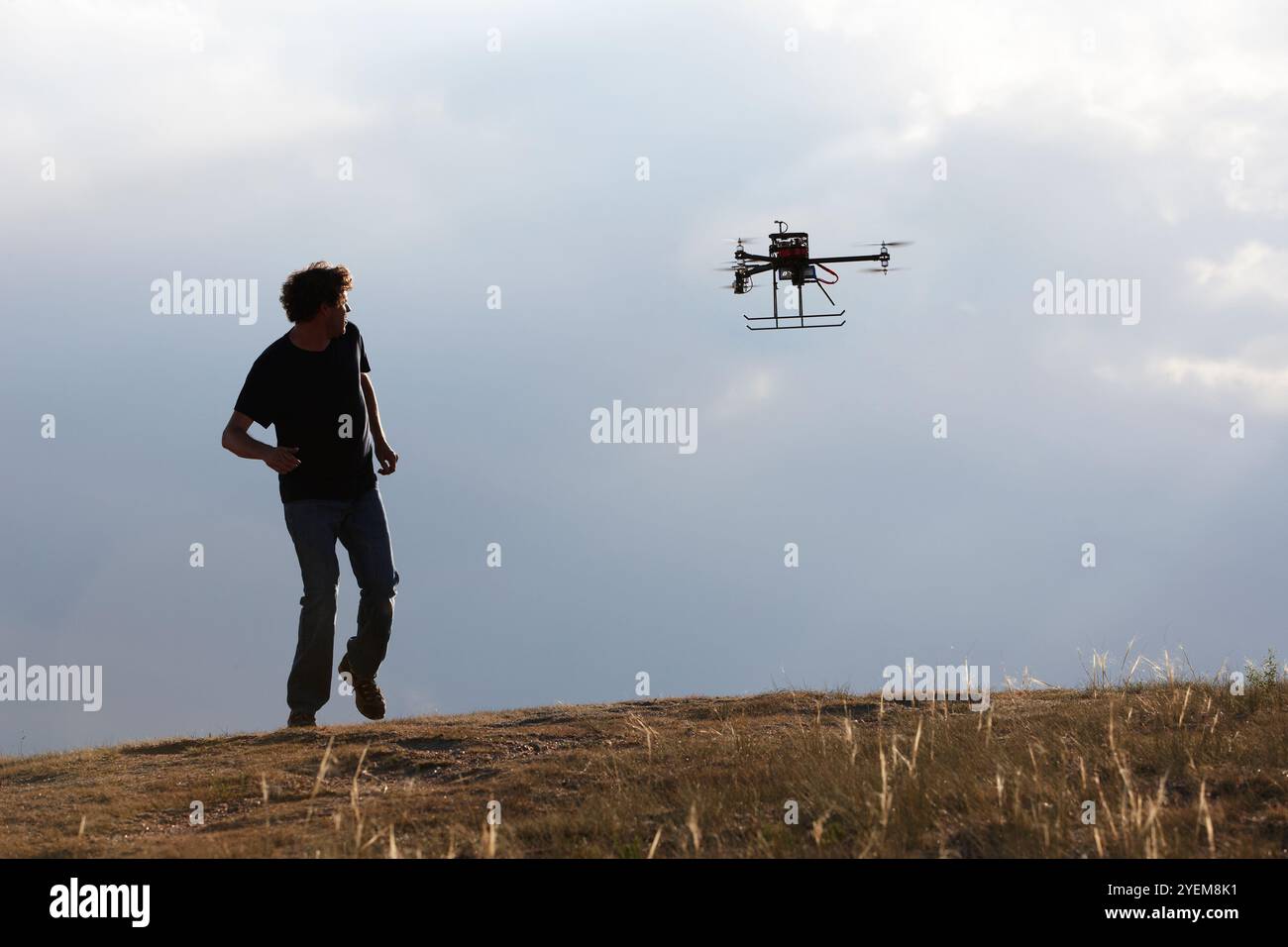 Man being pursued by a drone (UAV Stock Photo - Alamy