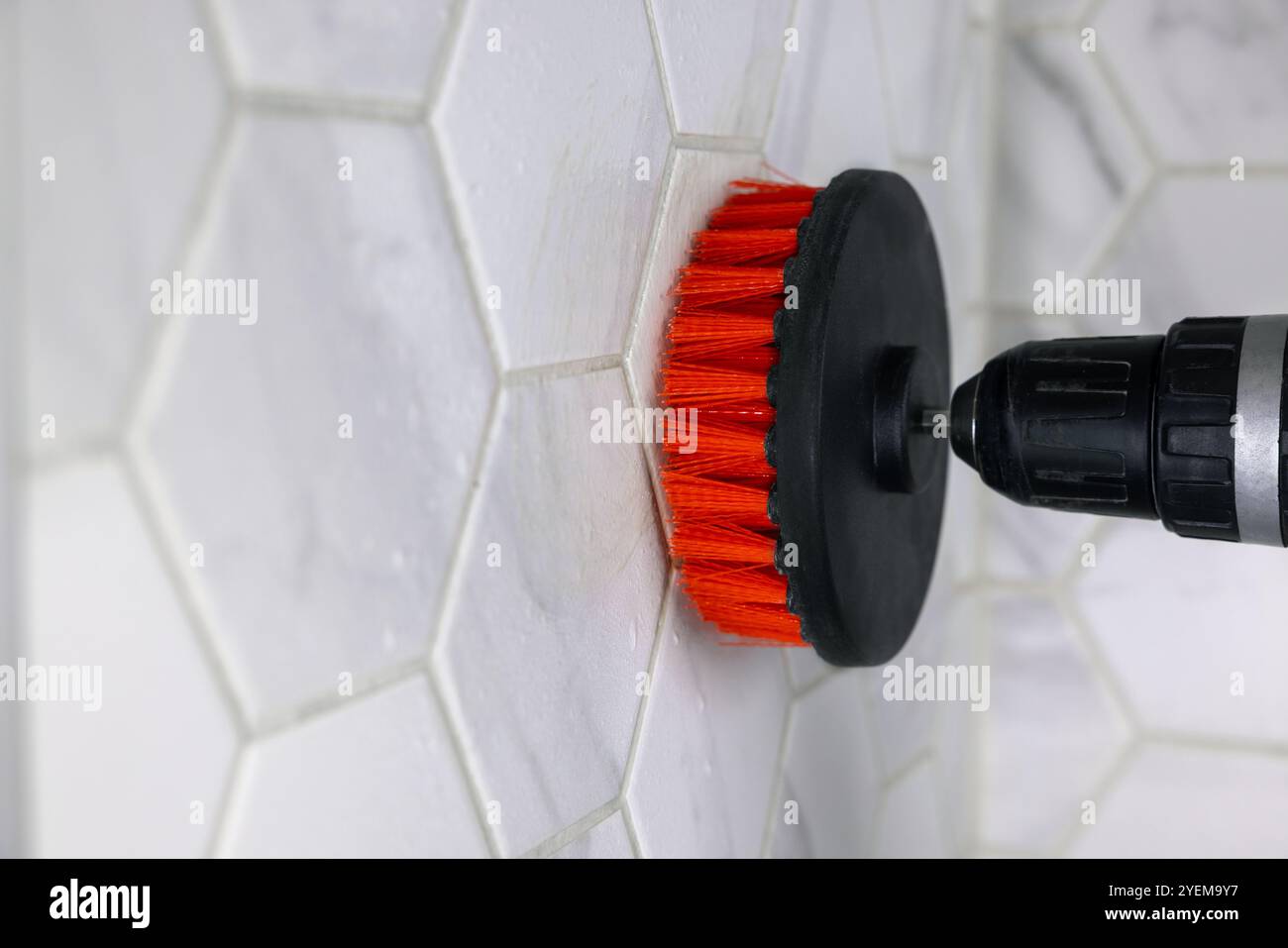 cleaning bathroom tiles with drill brush Stock Photo - Alamy