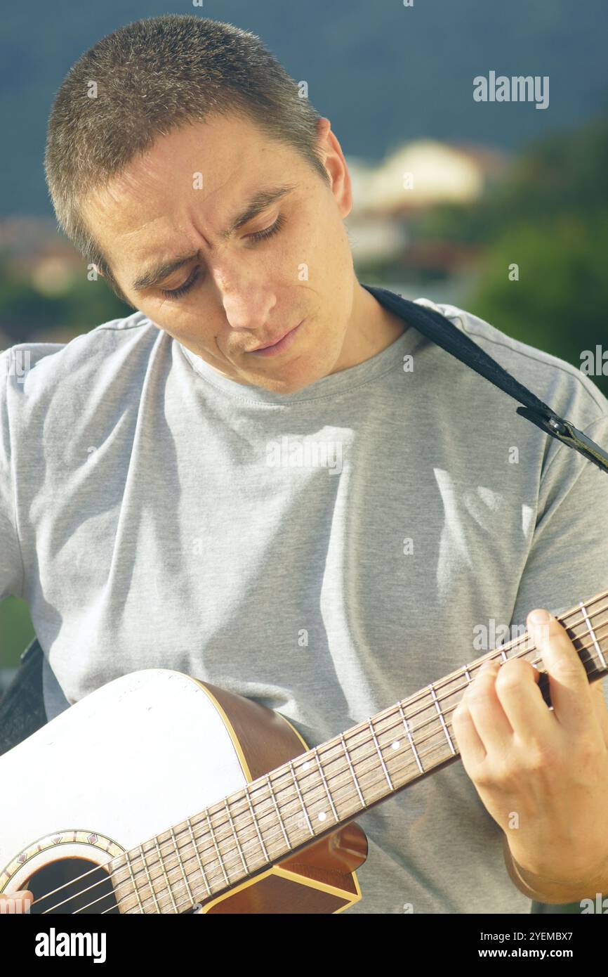 Portrait of a person doing what he loves: a man playing a six-string ...
