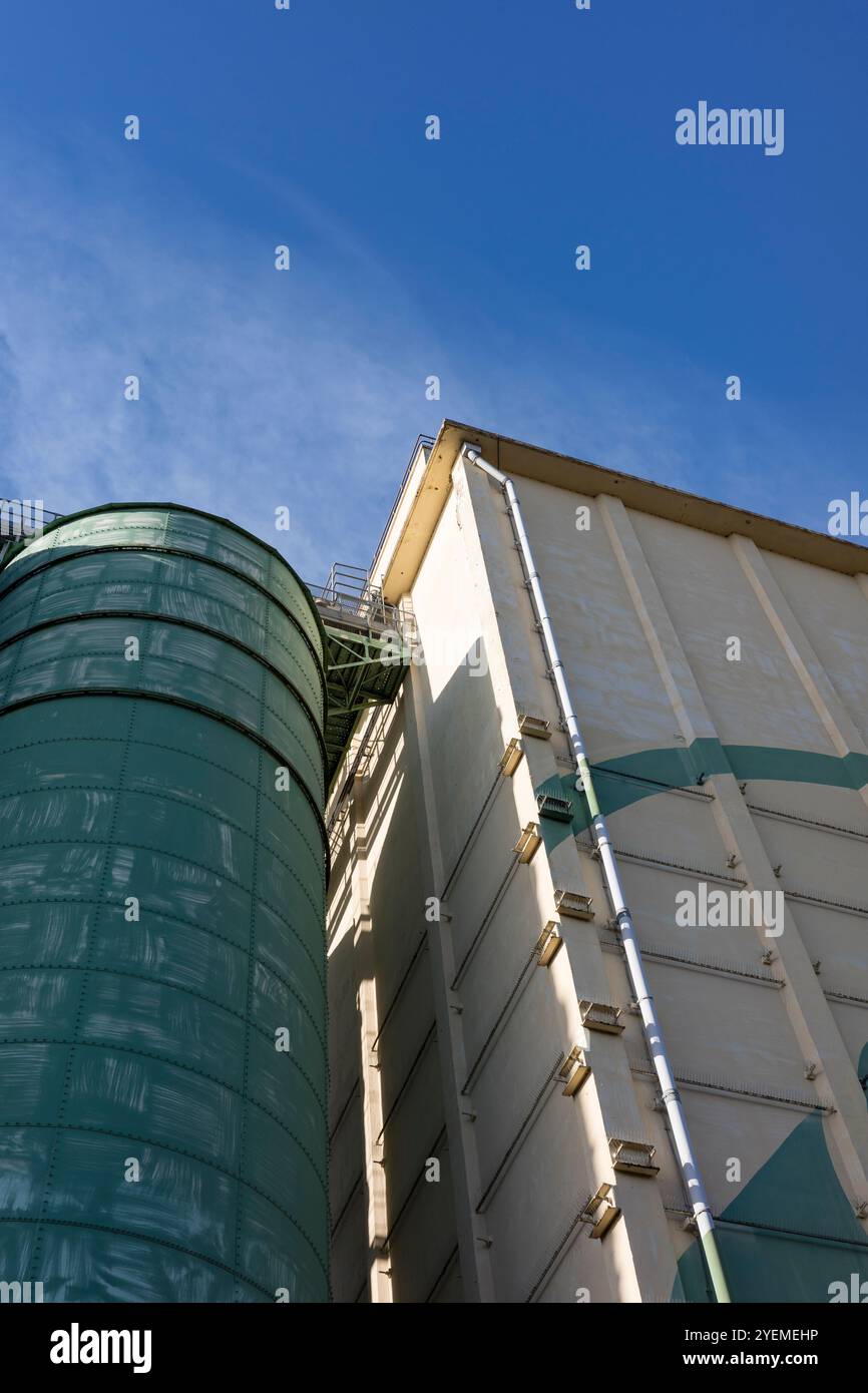 Industrial silos grain storage under a clear blue sky, showcasing ...