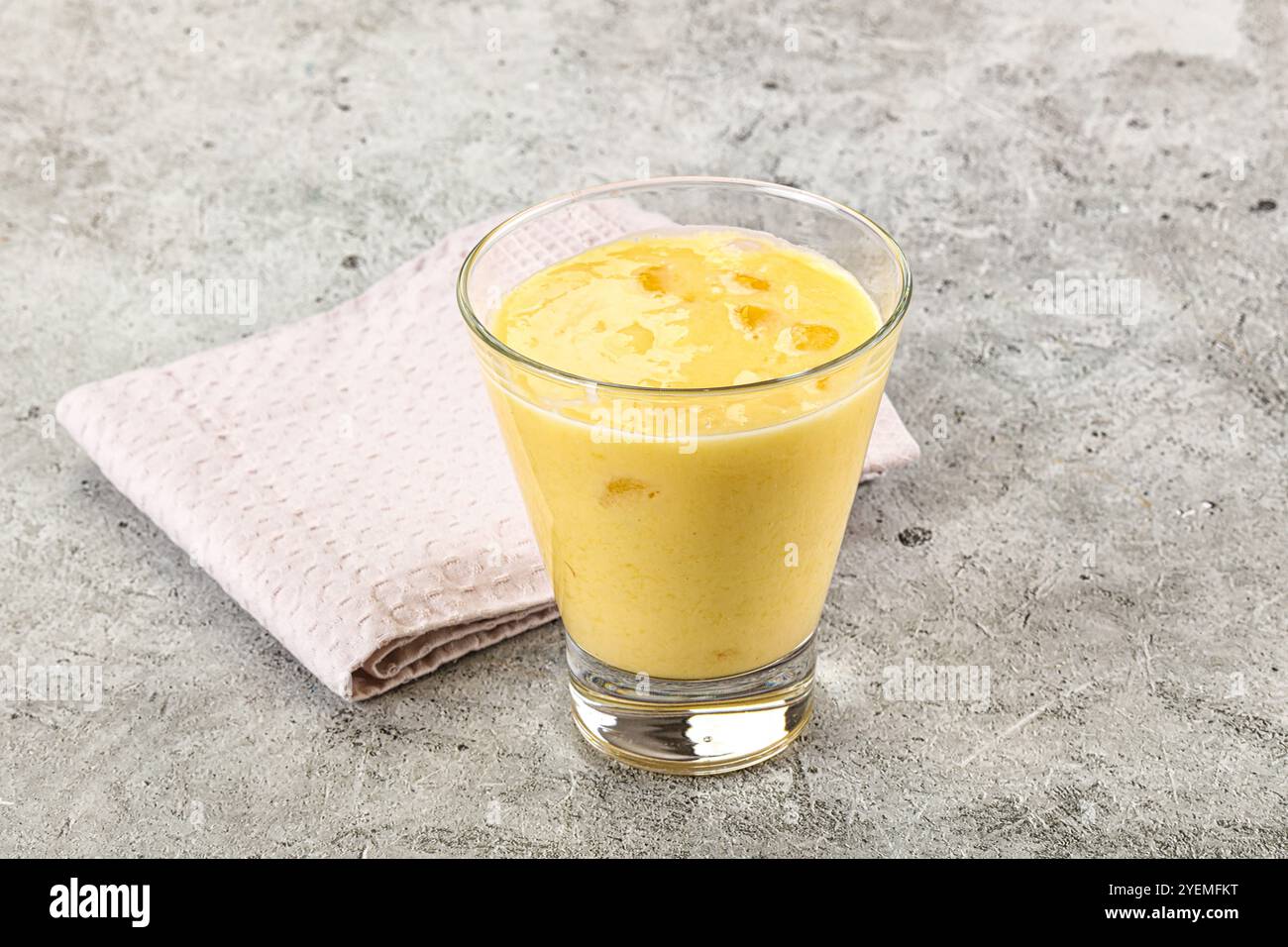 Cold sweet mango smoothie glass with ice Stock Photo - Alamy