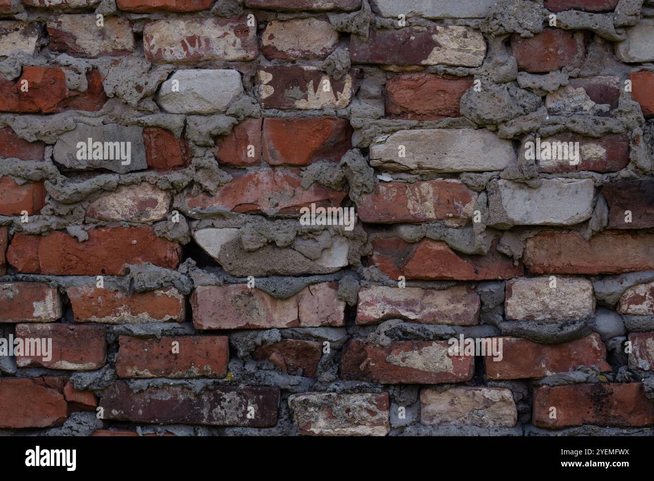 The brick wall of the castle is damaged. Brick wall background. Brick ...