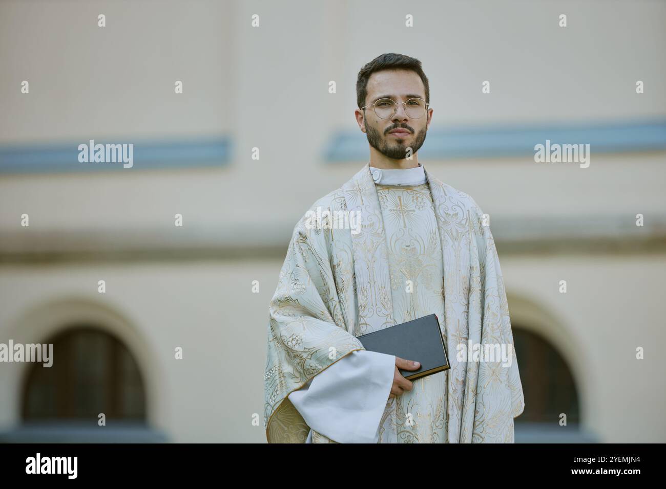 Smiling catholic priest holding hi-res stock photography and images - Alamy