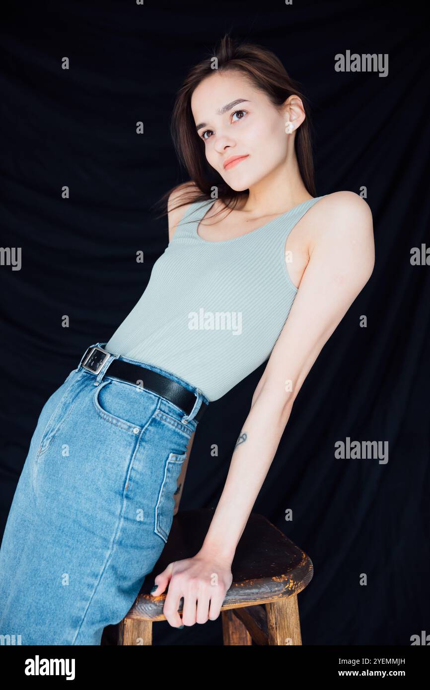 Portrait of Beautiful Slender Woman in Jeans on Black Background Stock ...