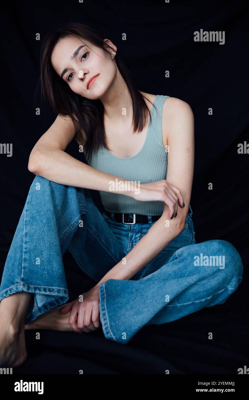 Portrait of Beautiful Slender Woman in Jeans on Black Background Stock ...