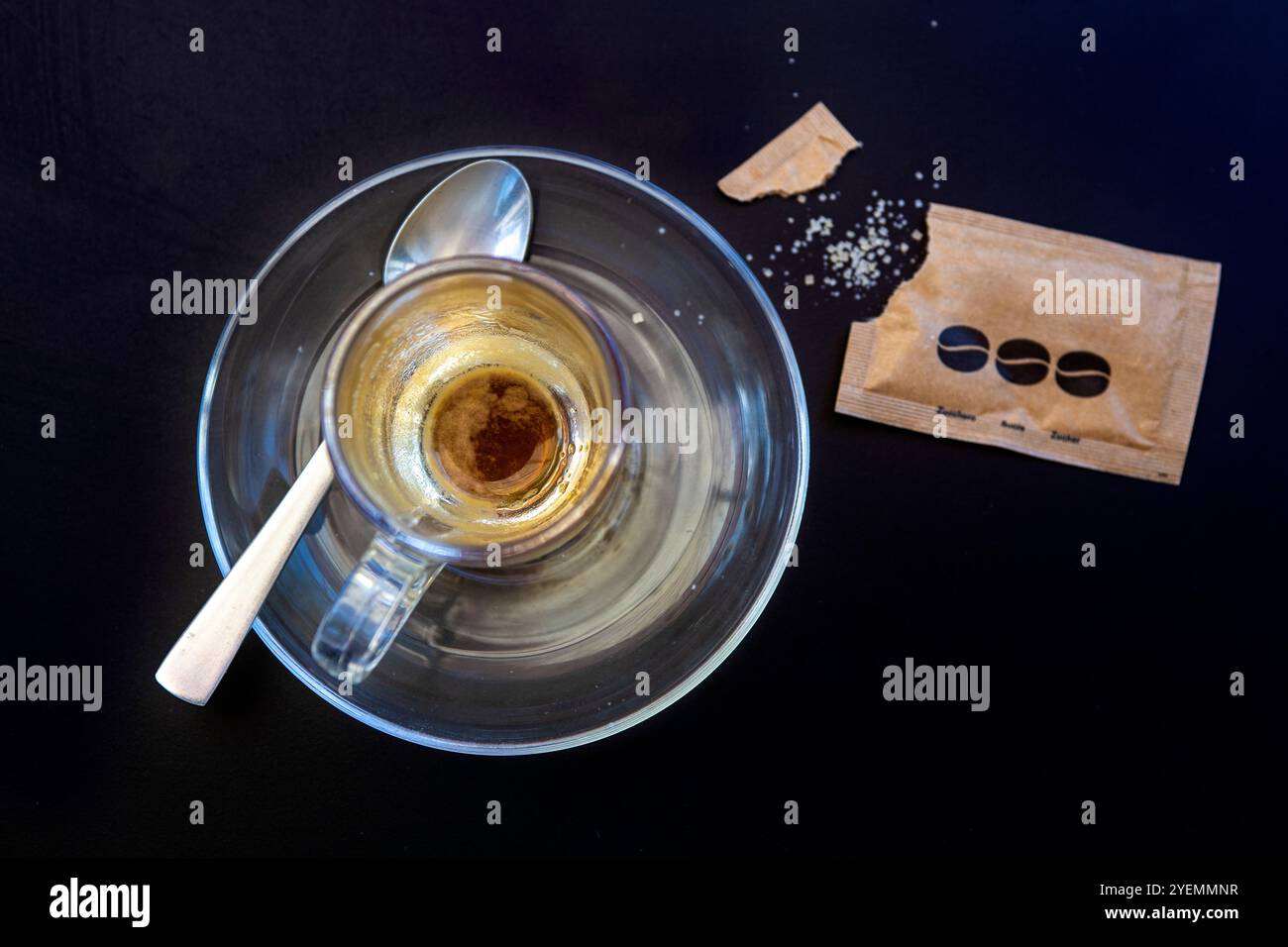 Empty espresso cup with open sugar packet on dark background Stock ...