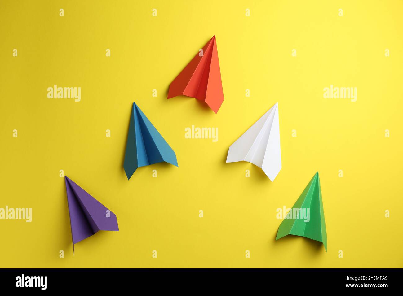 Handmade color paper planes on yellow background, flat lay Stock Photo ...