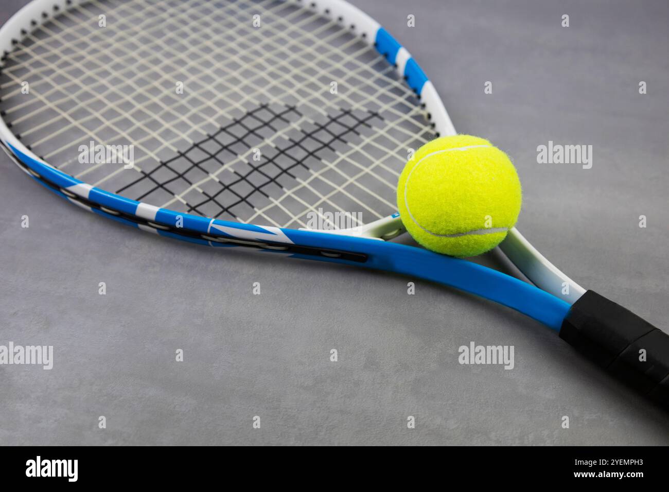 A beautifully designed tennis racket in a striking blue and white color ...