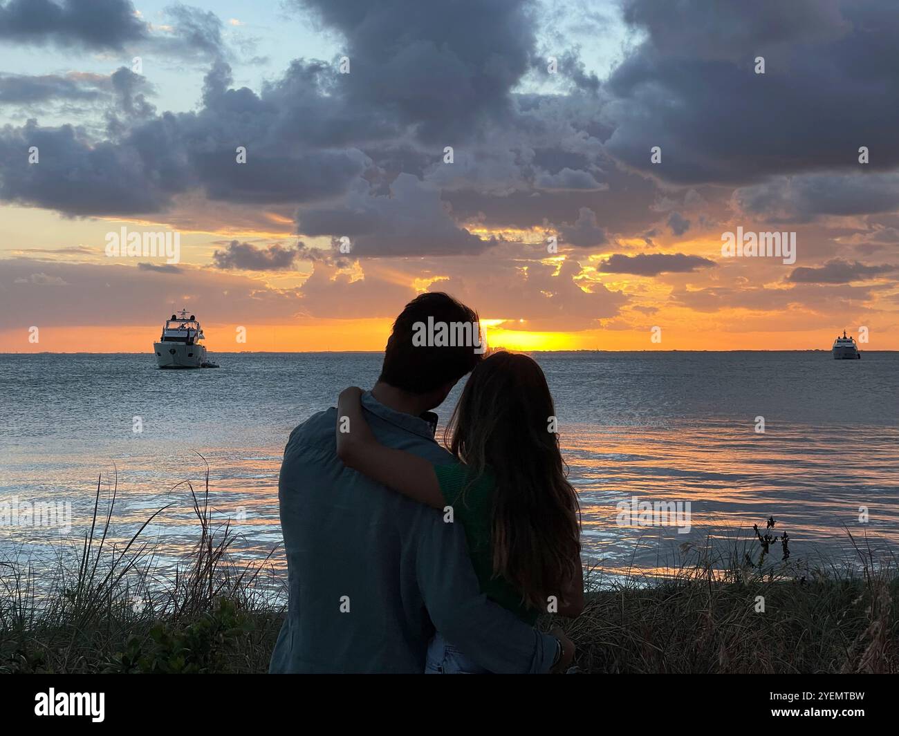 Couple contemplating the sunset, Key Biscayne, Florida, USA Stock Photo ...