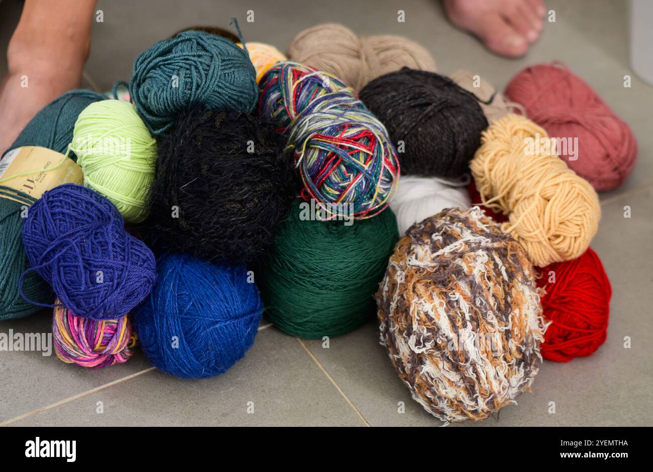 Various yarn balls in vibrant colors are neatly arranged, inviting ...