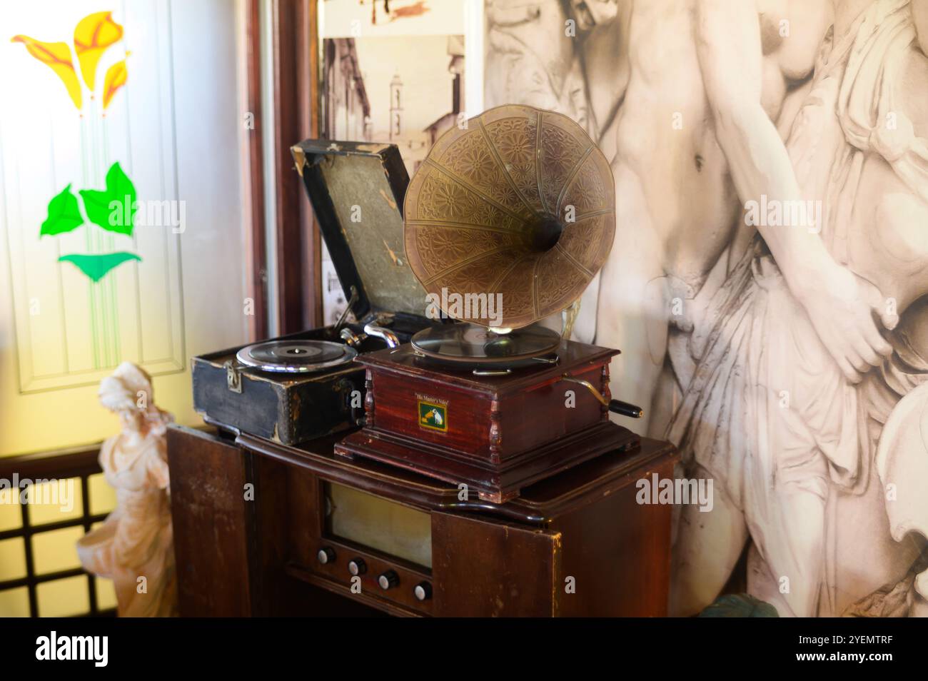 An antique gramophone showcases its intricate design, surrounded by ...