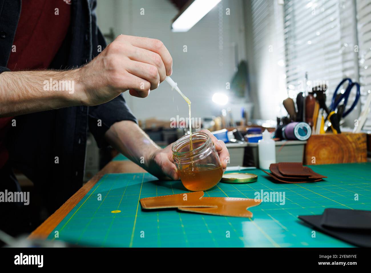 The hands of the master sew handmade leather products. Men's hands ...